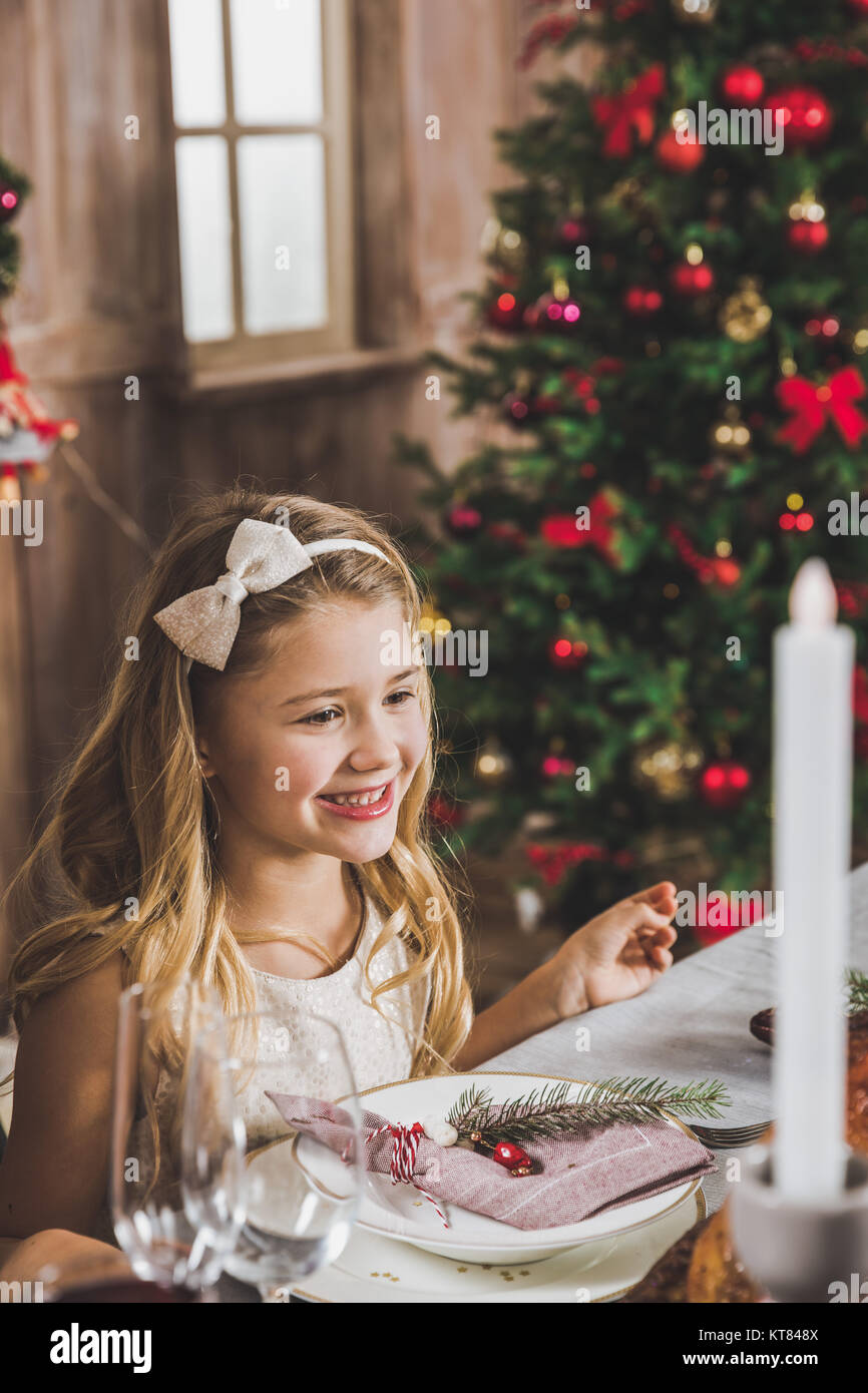 Cute girl at holiday table Stock Photo - Alamy