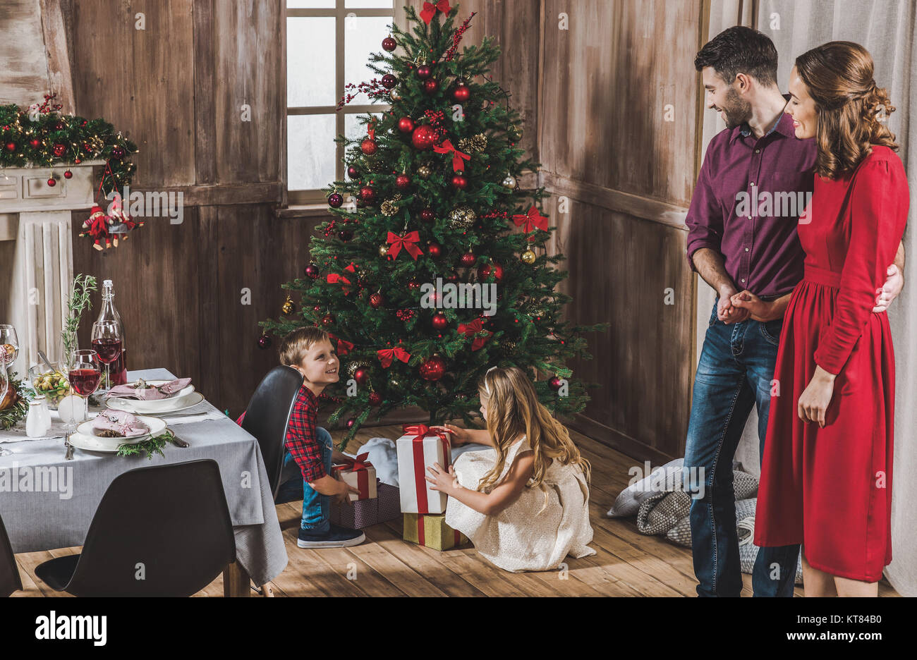 Smiling parents looking at children Stock Photo - Alamy