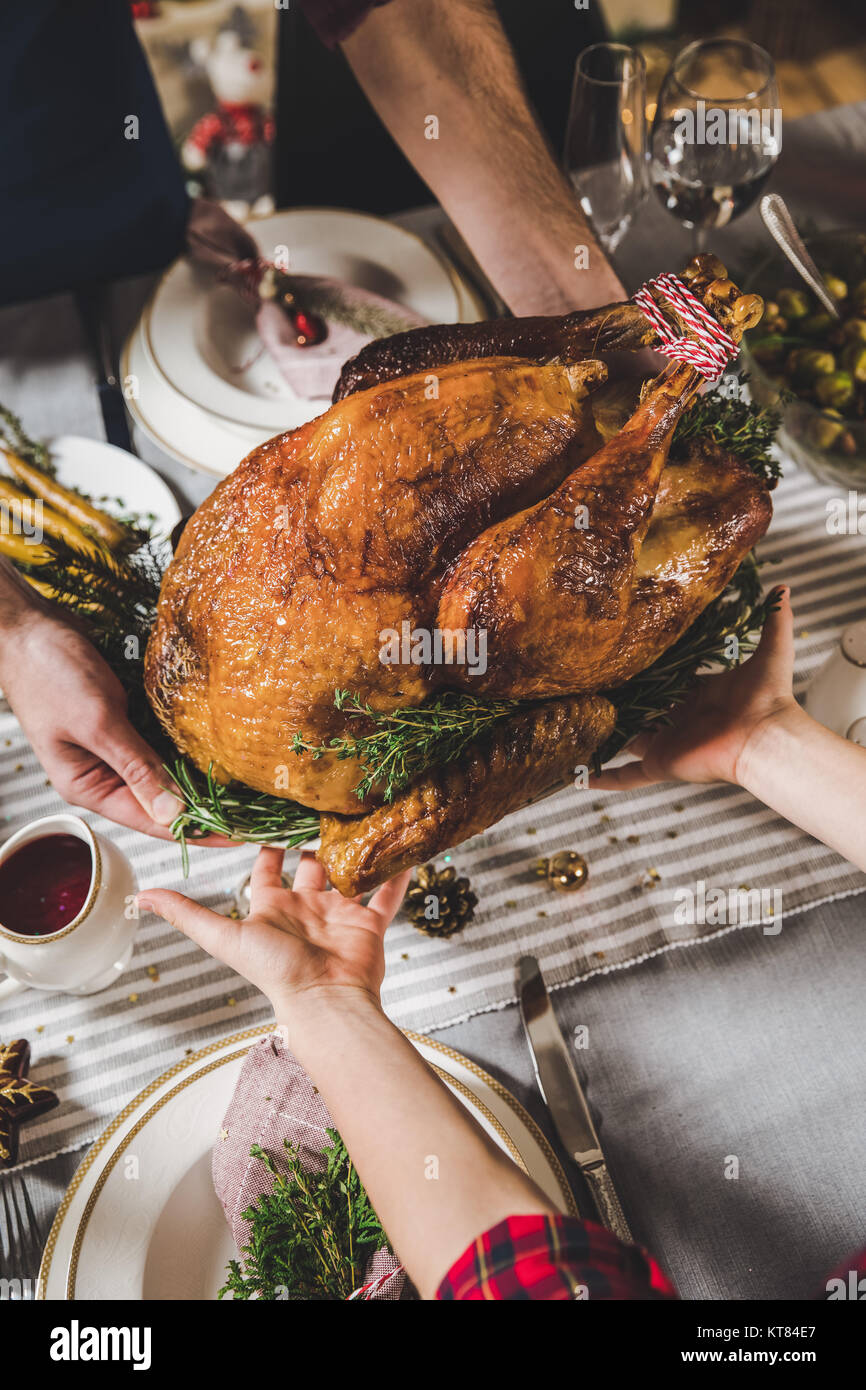 Father and son holding roasted turkey Stock Photo - Alamy