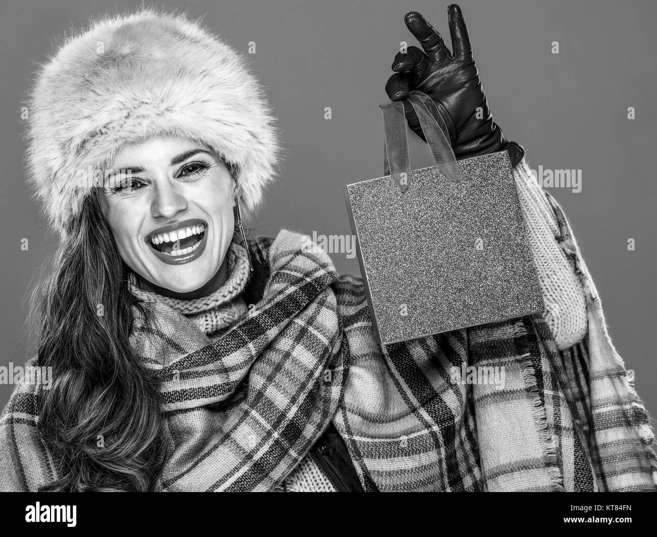 Winter things. smiling elegant woman in fur hat isolated on cold blue ... Winter things. smiling elegant woman in fur hat isolated on cold blue ...