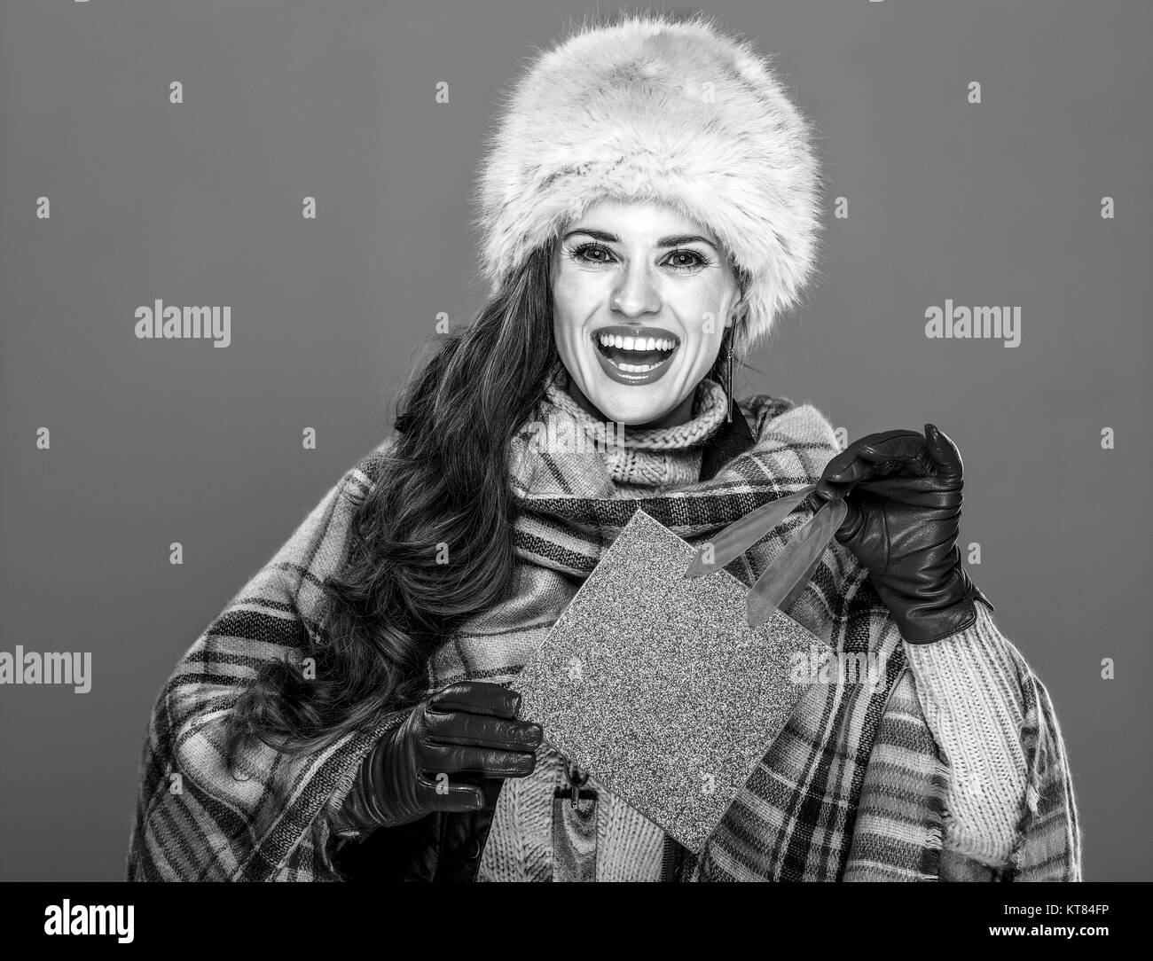 Winter things. Portrait of smiling elegant woman in fur hat isolated on ... Winter things. Portrait of smiling elegant woman in fur hat isolated on ...