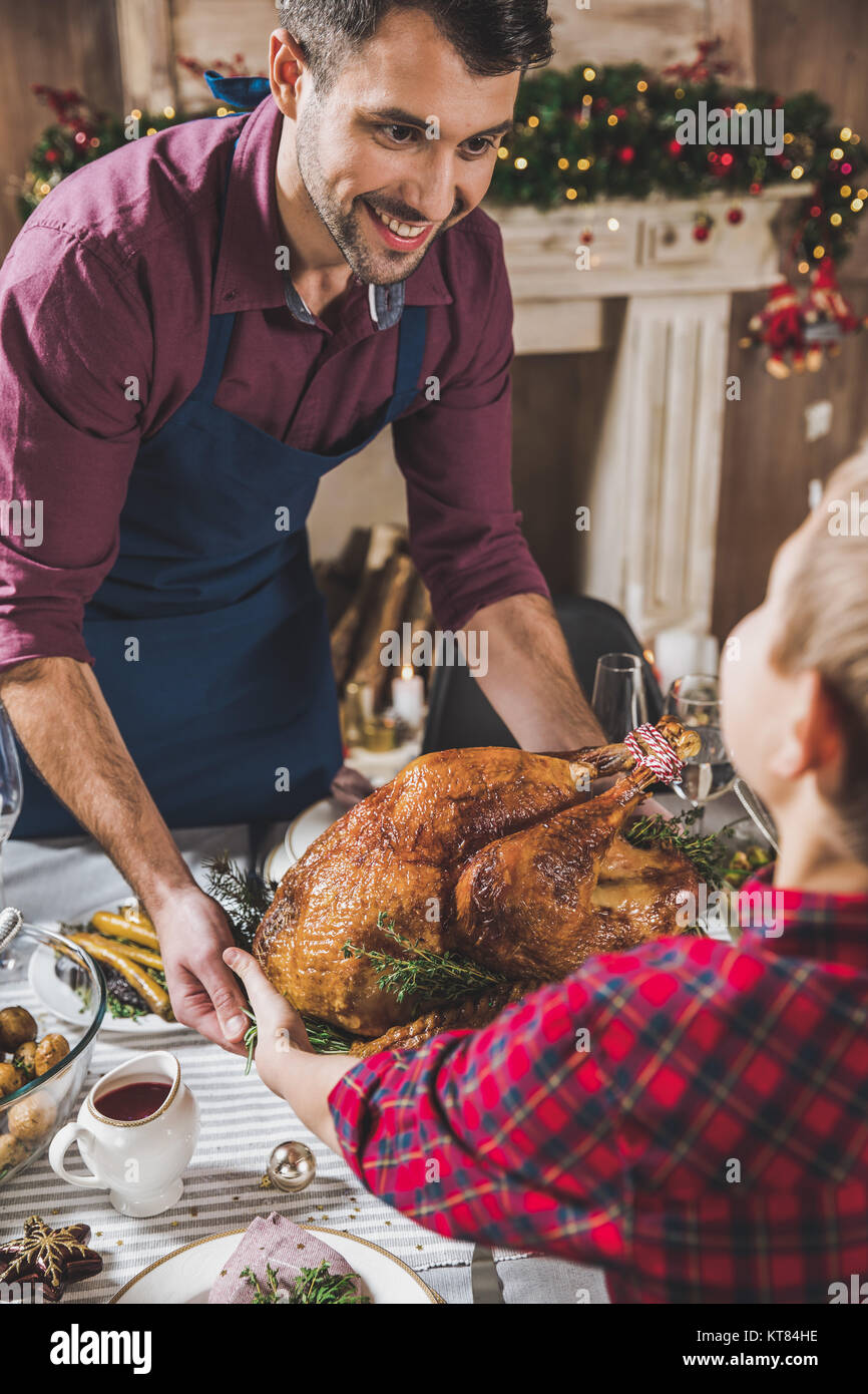 Father and son holding roasted turkey Stock Photo - Alamy