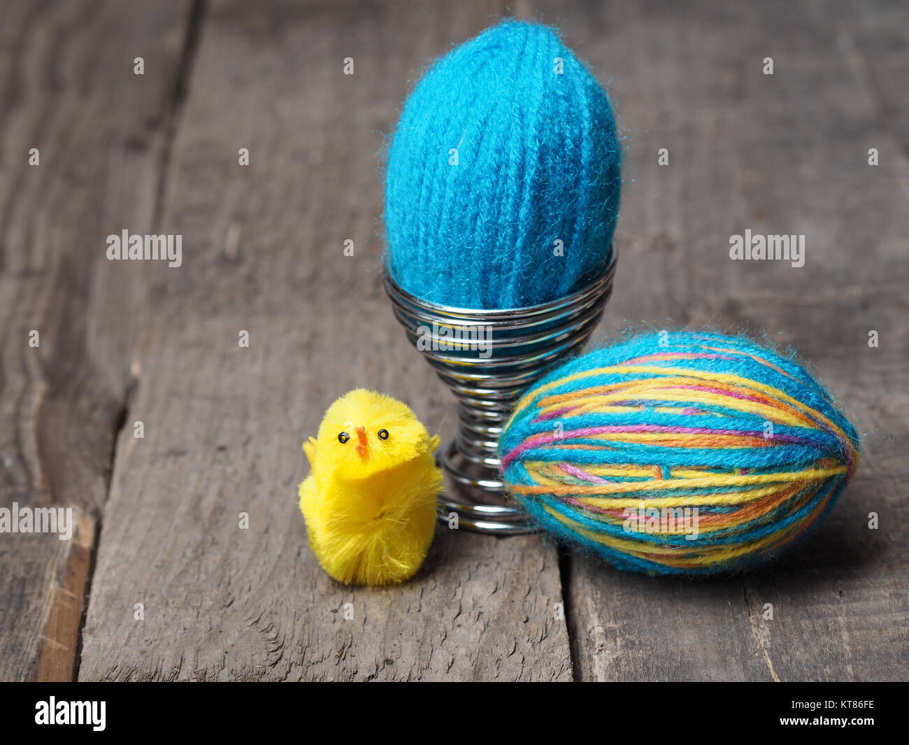 Two Easter eggs covered with wool yarn on a rutsic wooden table Stock ...