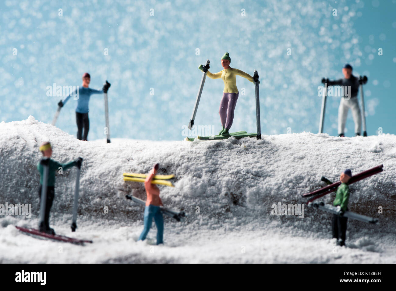 some different miniature skiers in a snowy landscape on winter time ...
