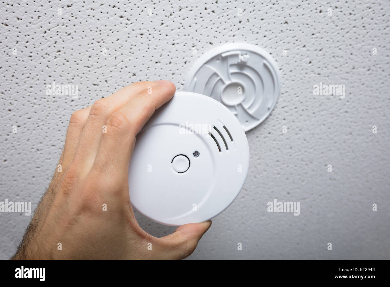 Person Repairing The Smoke Detector Stock Photo - Alamy