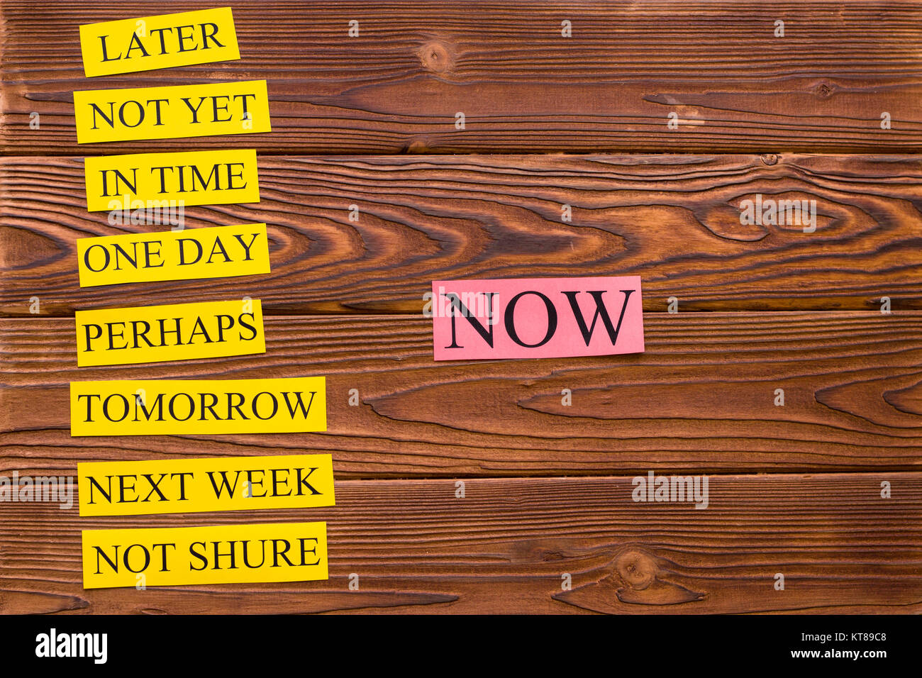 Do not delay work. Motivation words on a rustic wooden table. Space for ...