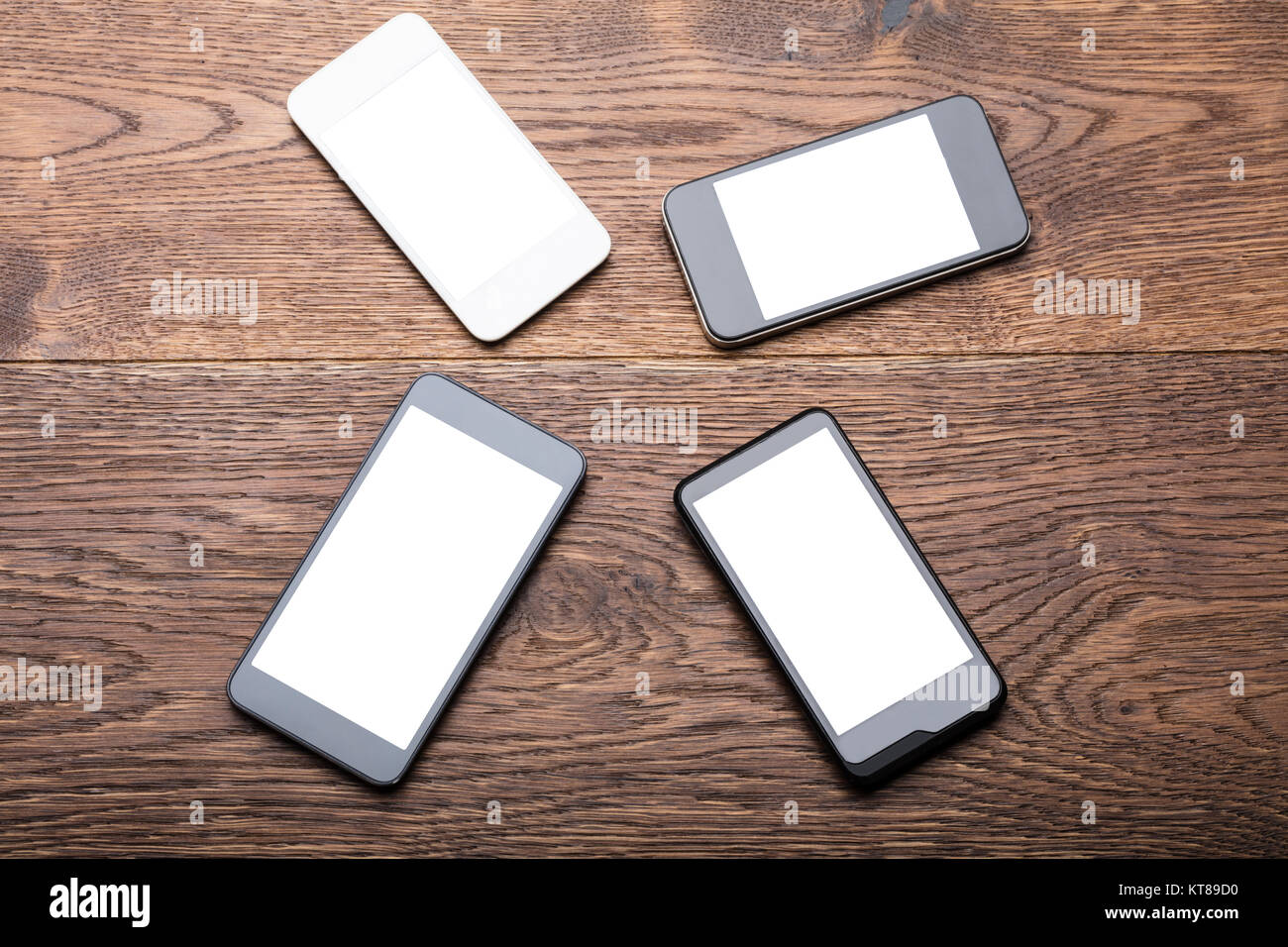 Group Of Mobile Phones On Wooden Desk Stock Photo - Alamy