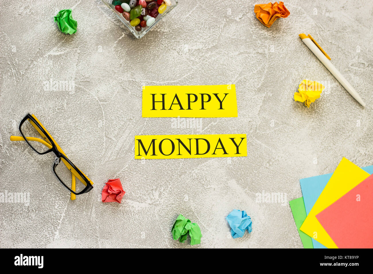 Happy monday inscription printed on a yellow paper in a frame of office ...
