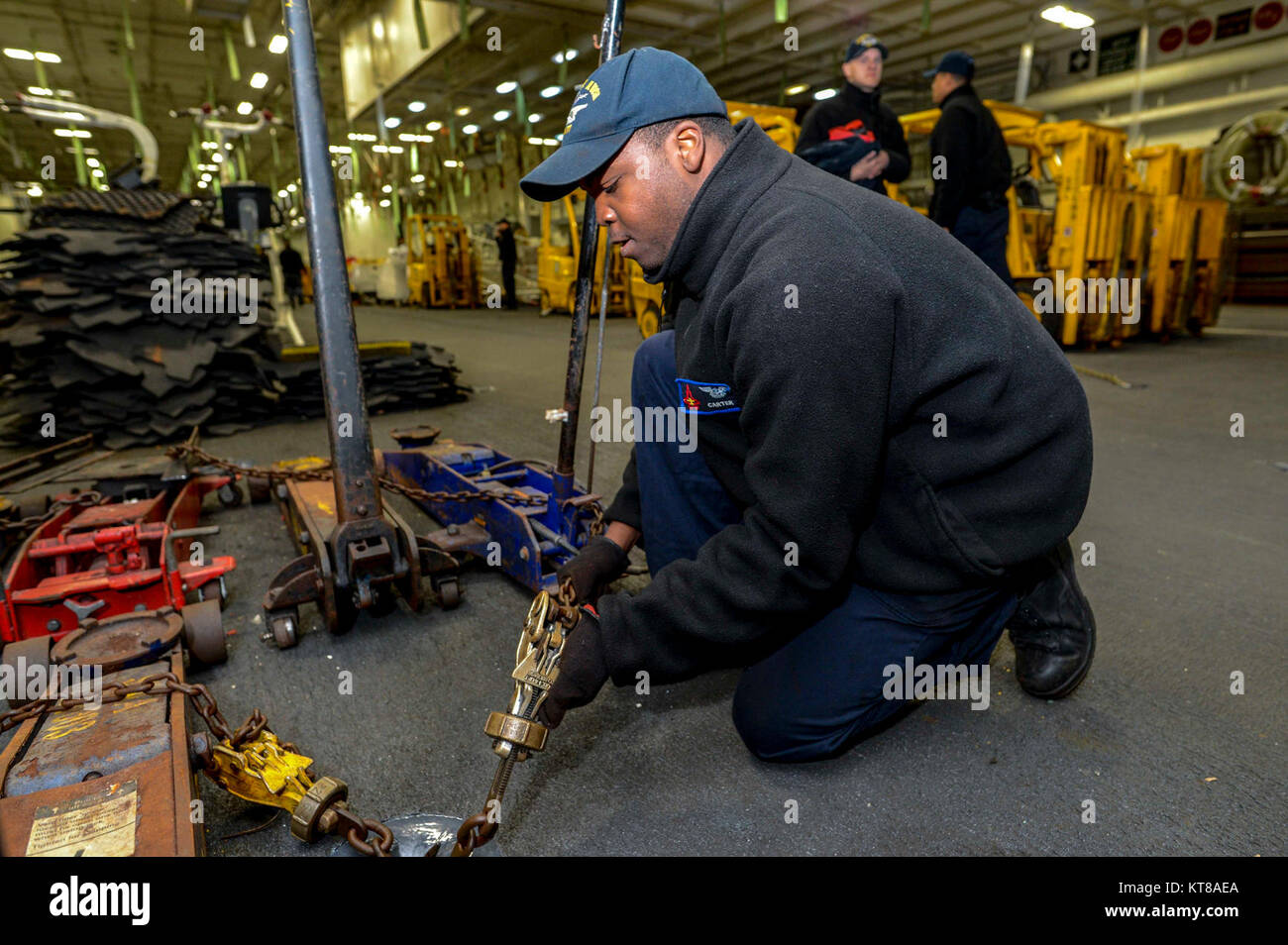 Aviation Support Equipment Technician 3rd Class Alvin Carter secures a ...
