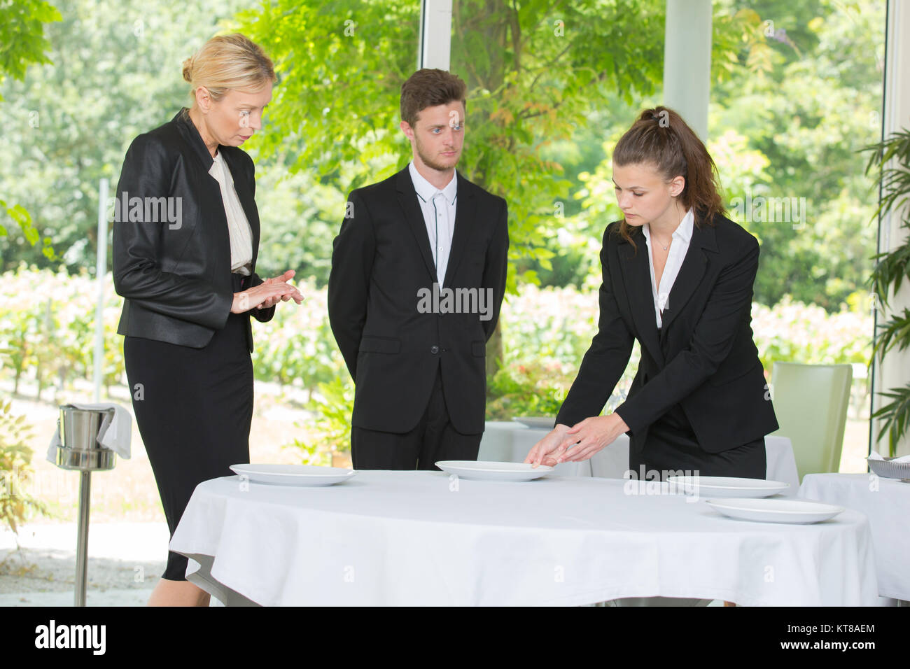 Waitress learning how to prepare table Stock Photo - Alamy