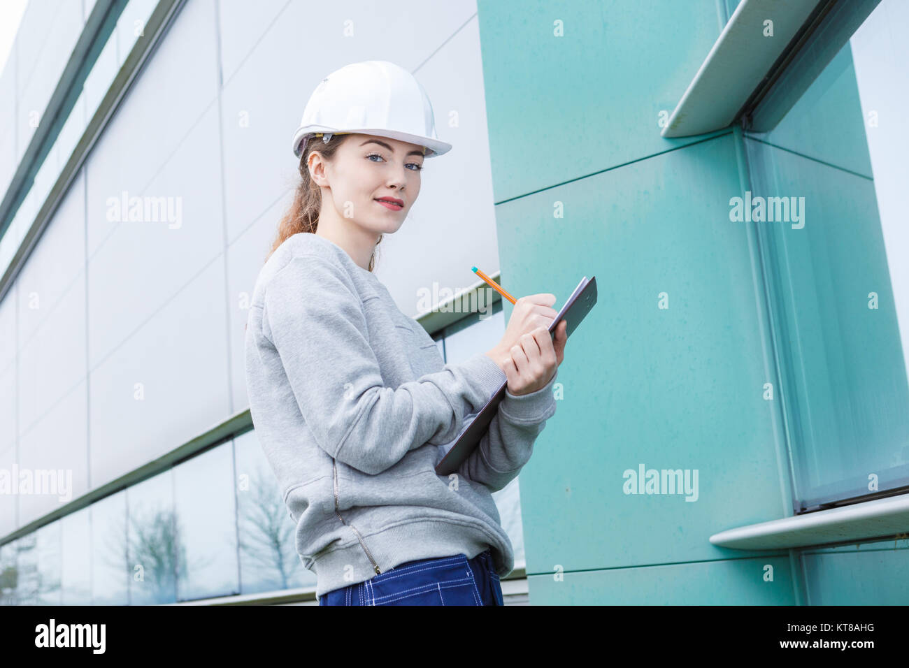 Portrait of lady with clipboard outside a building Stock Photo - Alamy