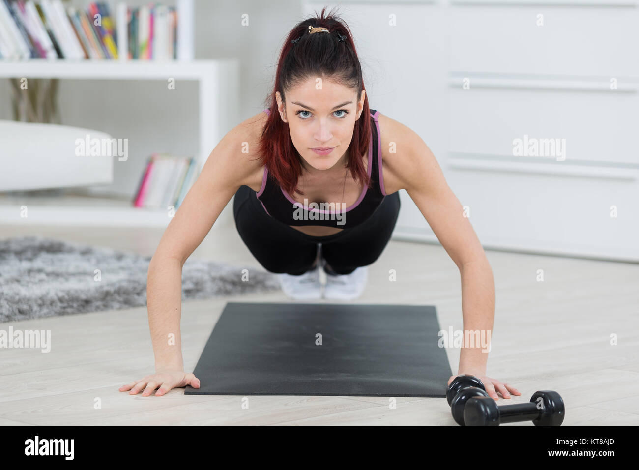 Woman in plank exercise position Stock Photo - Alamy