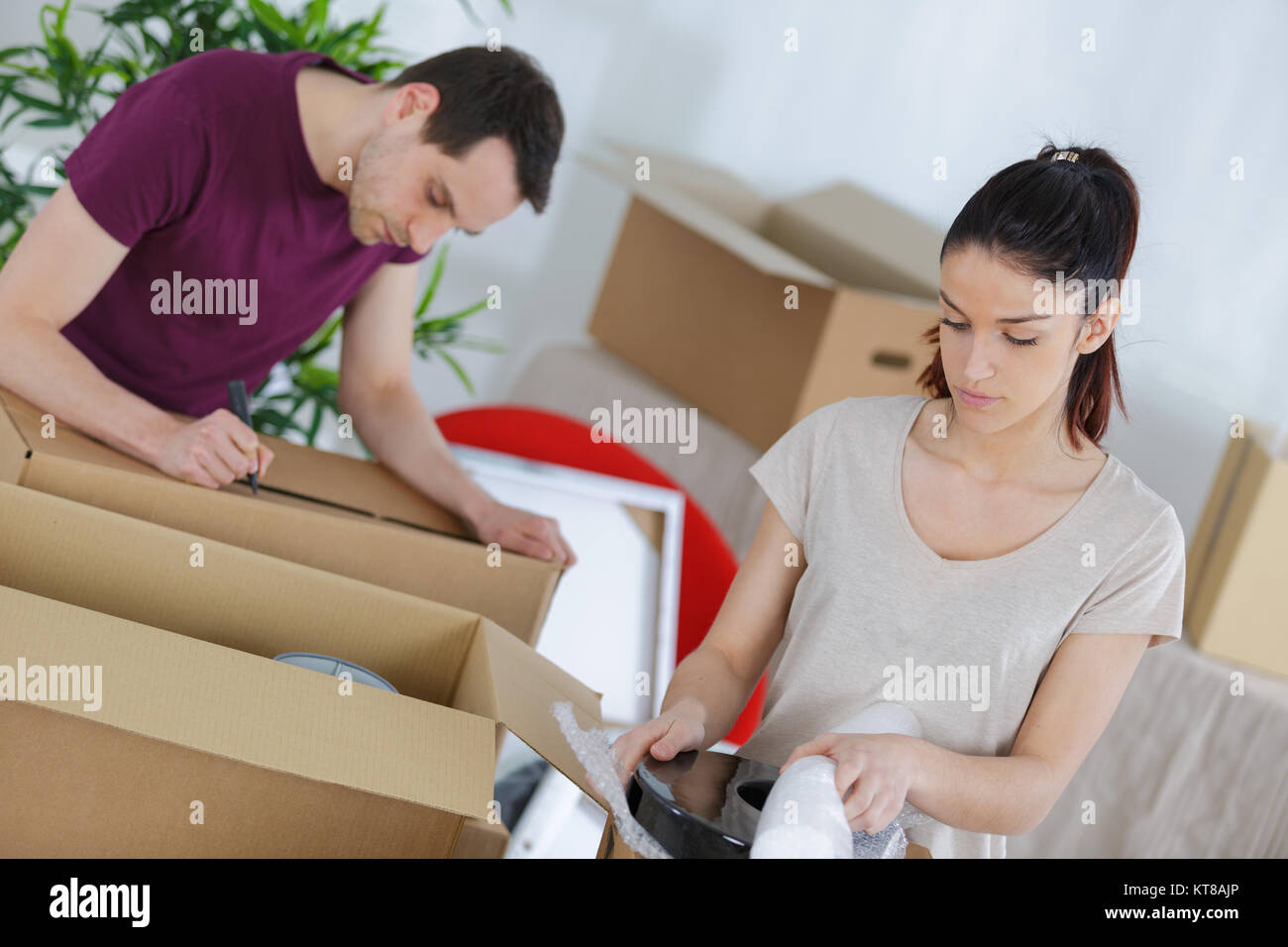 young couple unpacking or packing boxes Stock Photo - Alamy
