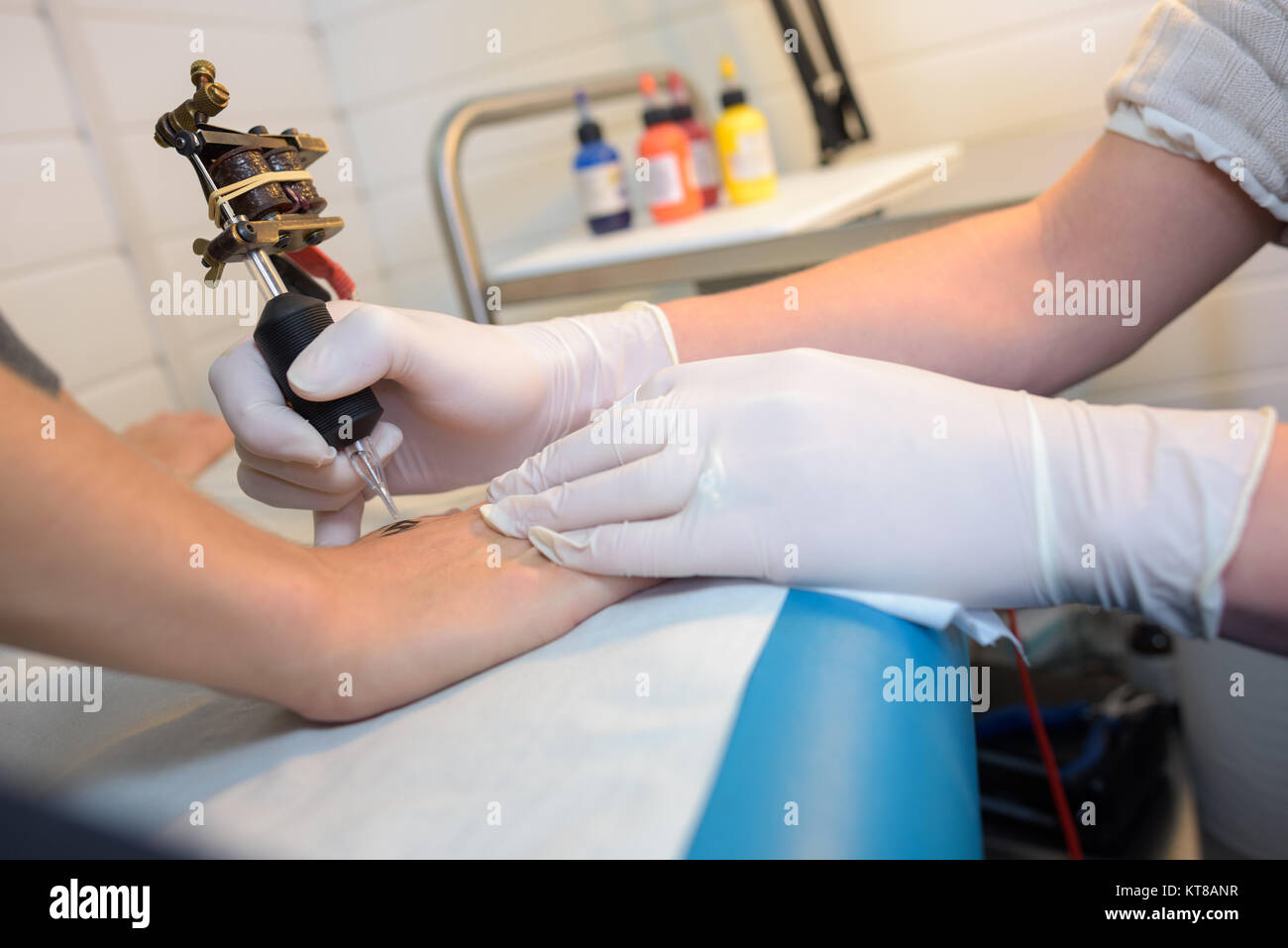 tattooist create tattoo in tattoo studio Stock Photo - Alamy