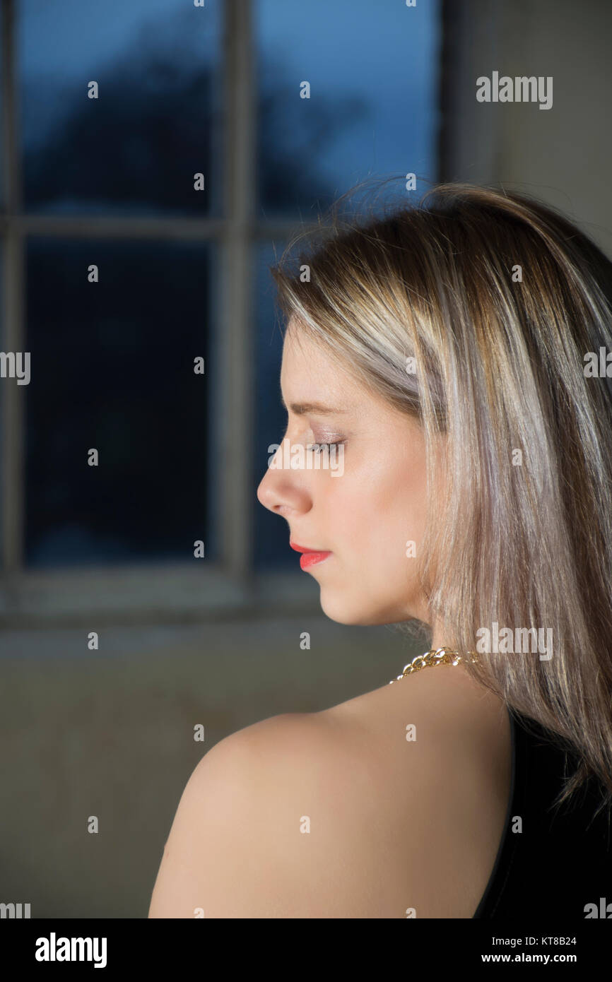 Sad woman looking down Stock Photo - Alamy