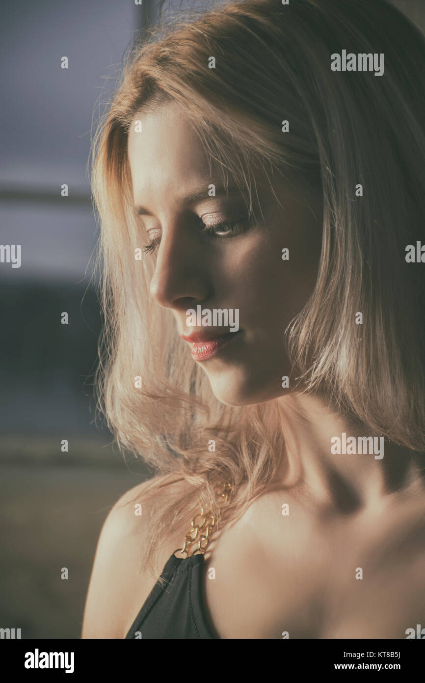 Portrait of a beautiful woman looking down Stock Photo - Alamy