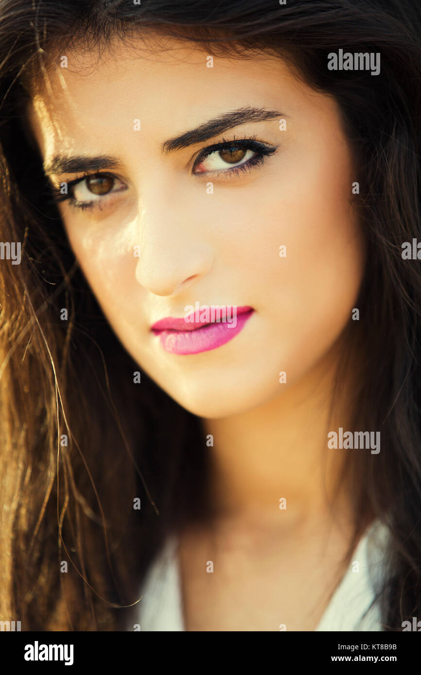 Serious young woman staring outdoors Stock Photo - Alamy