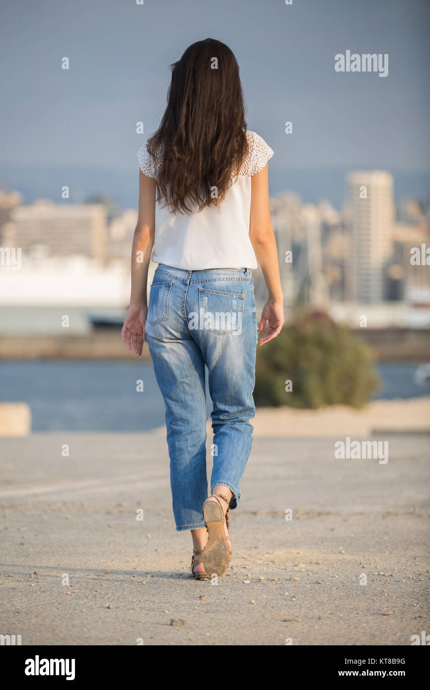 Woman walking back view hi-res stock photography and images - Alamy