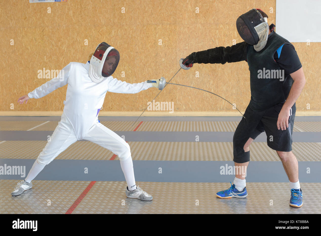 Man and woman practicing fencing Stock Photo - Alamy