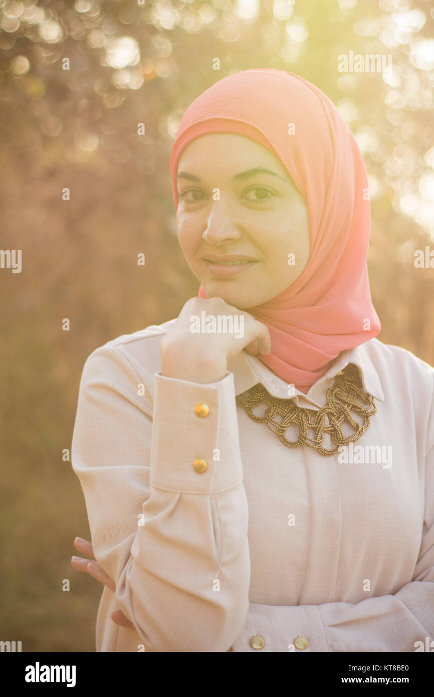 Beautiful Muslim woman hand touching chin smiling outdoors Stock Photo ...