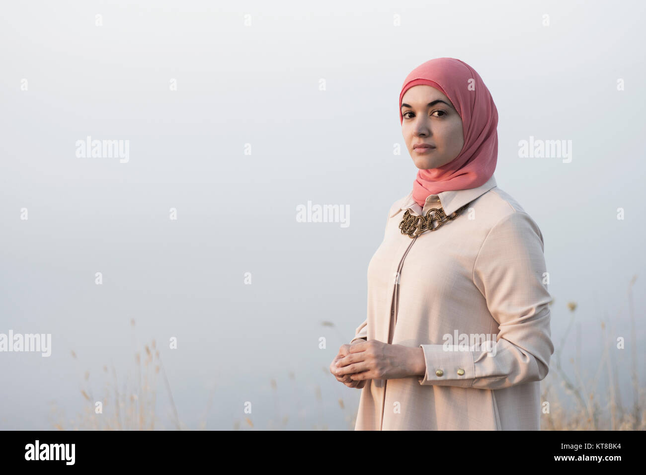 Serious Muslim woman standing outdoors Stock Photo - Alamy