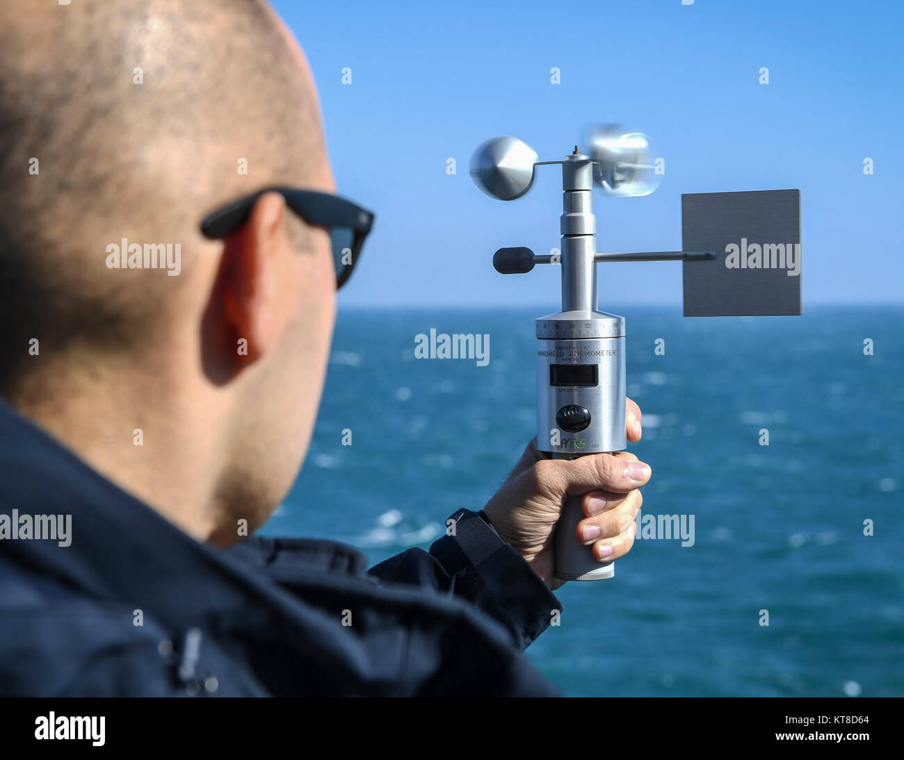 Aerographer’s Mate 2nd Class Michael Rodriguez uses an anemometer to ...