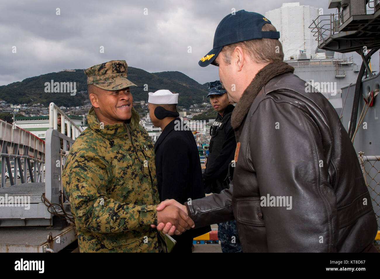 Capt. Larry McCullen, right, commanding officer of the amphibious ...