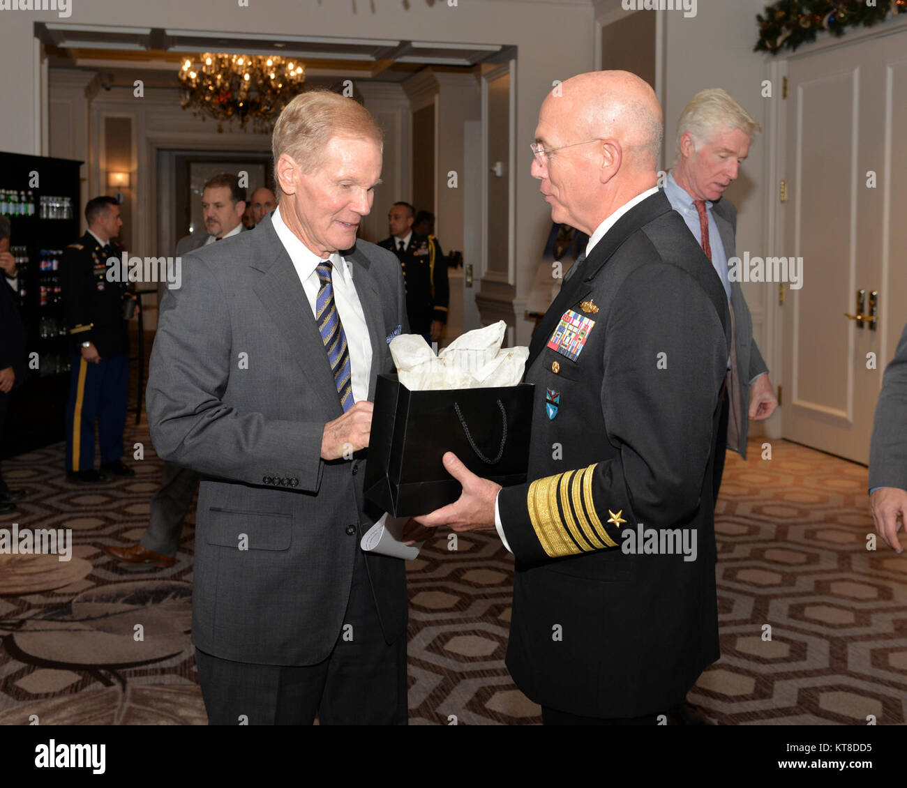Bill Nelson, left, U.S. Senator from Florida, accepts a gift from Adm ...