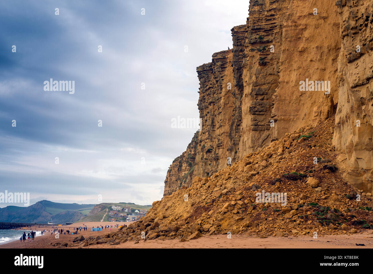 A huge cliff fall of sandstone from East Cliff spills on to the beach ...