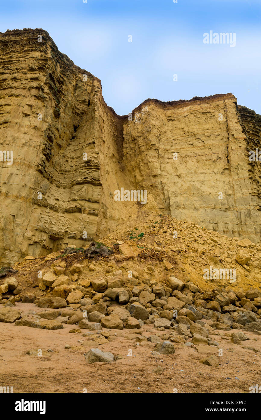 A huge cliff fall of sandstone from East Cliff spills on to the beach ...