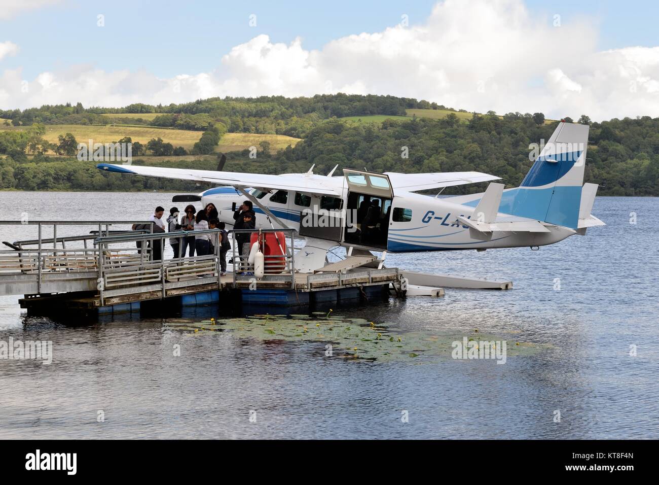 Passengers assemble on the jetty before boarding the floatplane on Loch ...