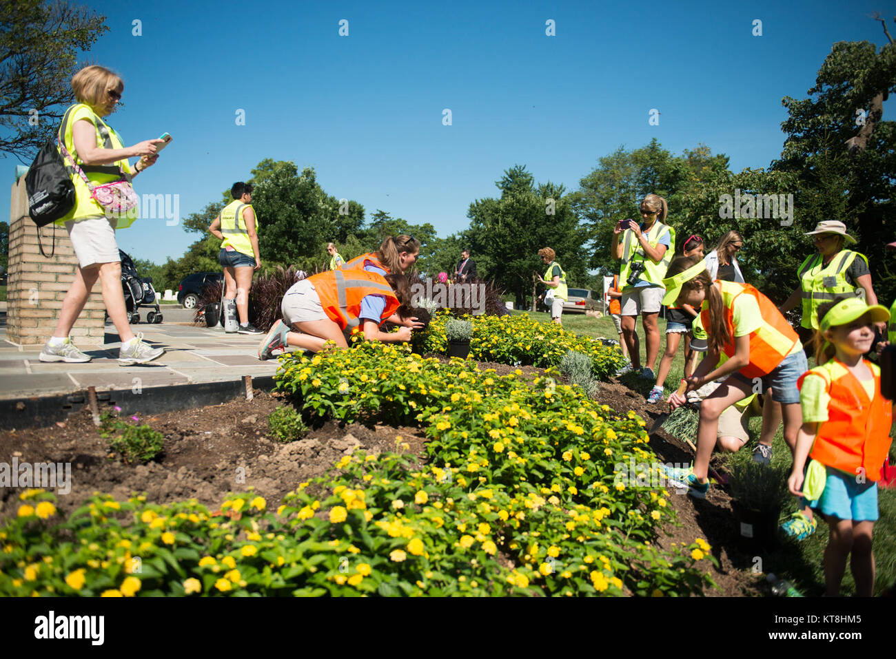 Youth volunteers plant flowers near the Spanish American War Memorial ...