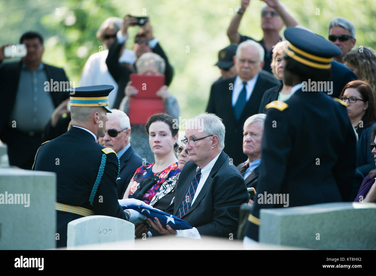 Kenneth Elder, executor, receives the American flag from U.S. Army Capt ...