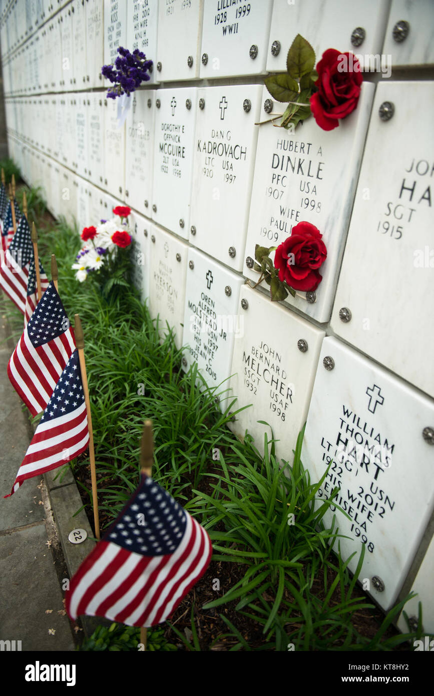 Columbarium niches are decorated with flowers and American flags on ...