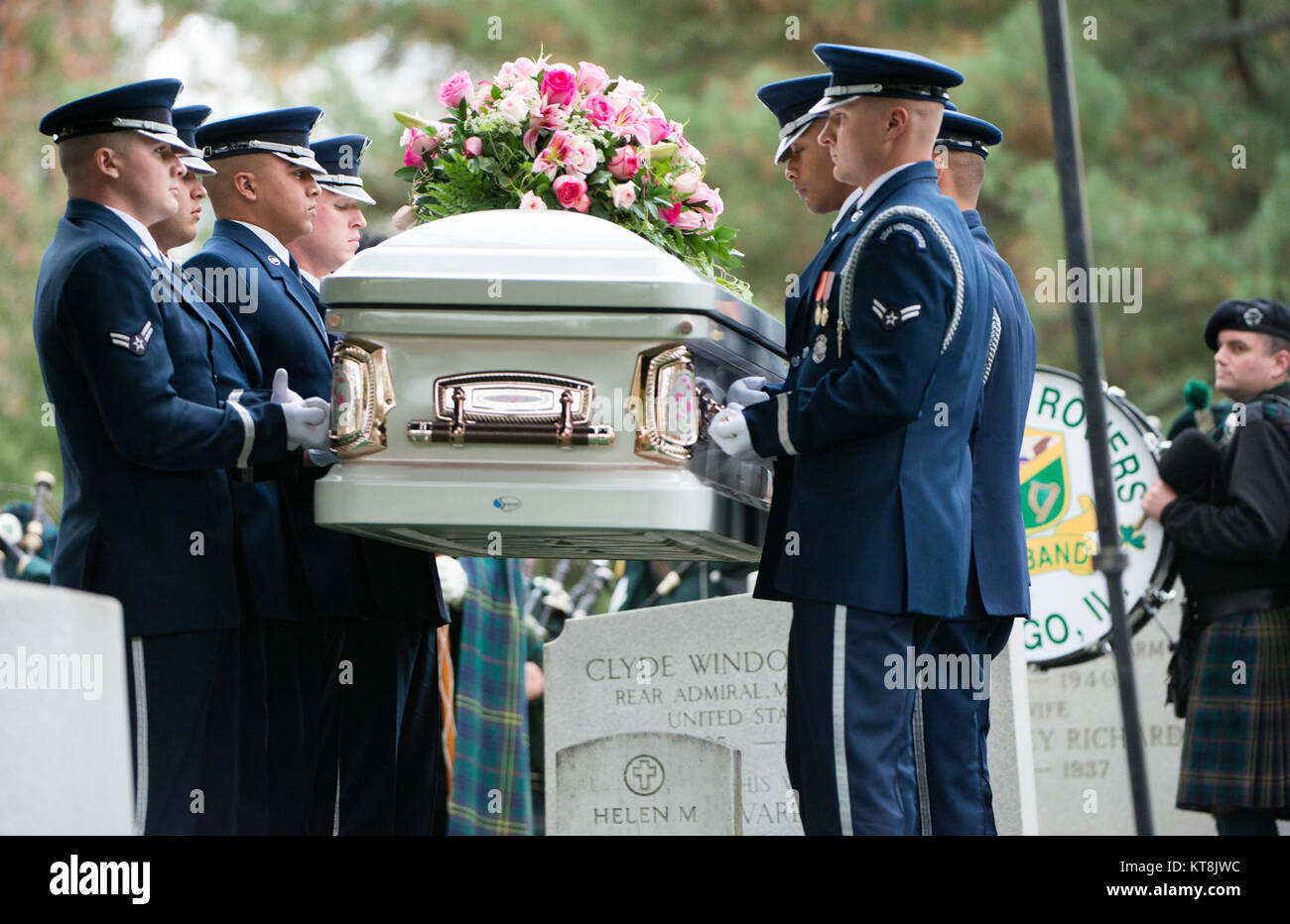 U.S. Air Force Honor Guard casket team carries the casket during the graveside service for ...