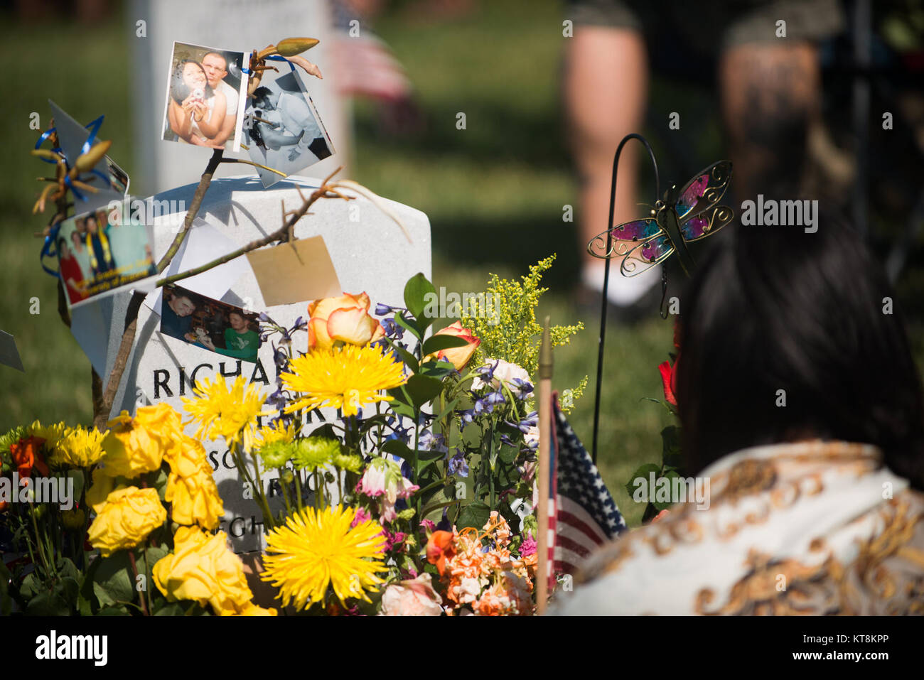 Laureen Lopez-Berry, right, sits at the grave of her husband, Richard ...