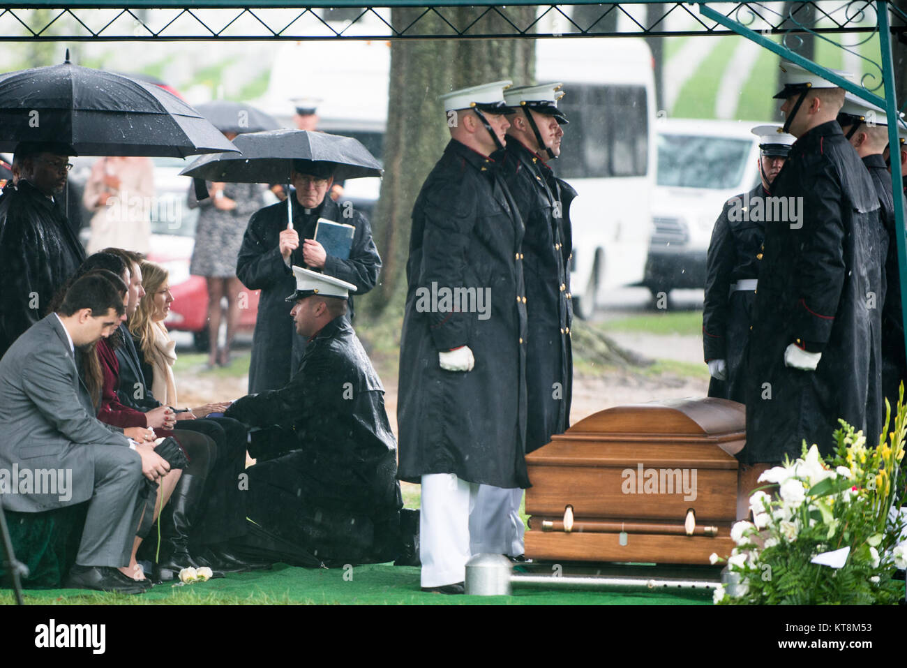 U.S. Marine Staff Sgt. John Lapinski, kneeling, presents the American ...
