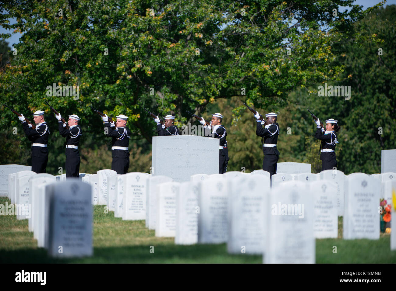 The U.S. Navy Ceremonial Guard participate in the graveside service of ...