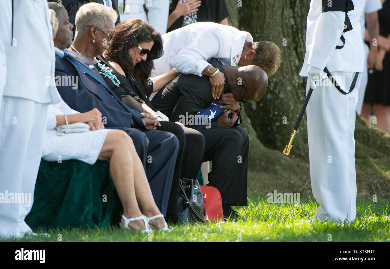 Darrell Martin embraces the American flag during the graveside service ...