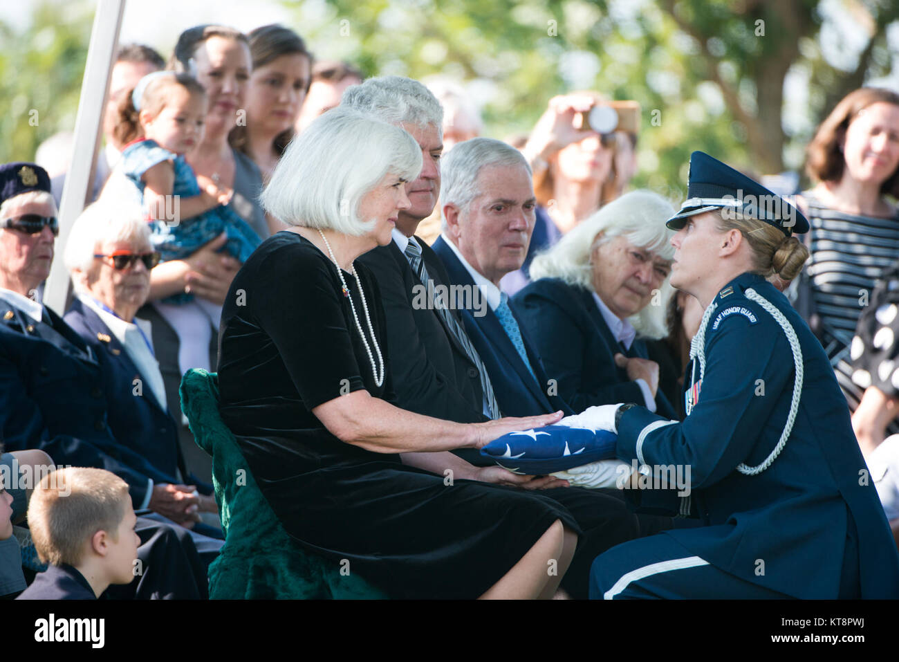 U.S. Air Force Capt. Jennifer Lee, right, presents the American flag to ...