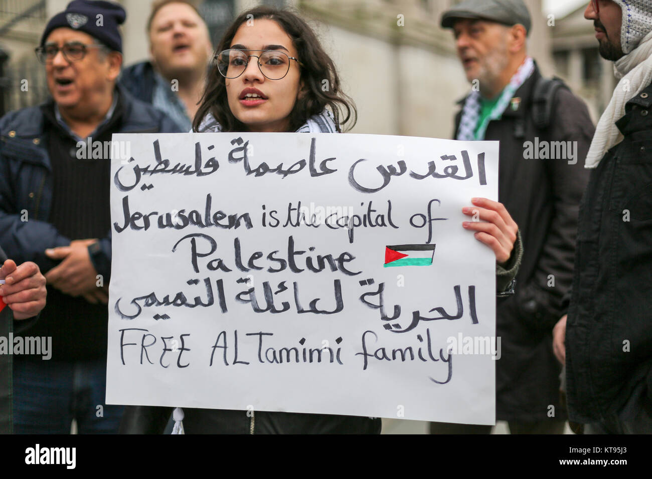 London, UK. 23rd Dec, 2017. A demonstrator holds a bilingual protest ...