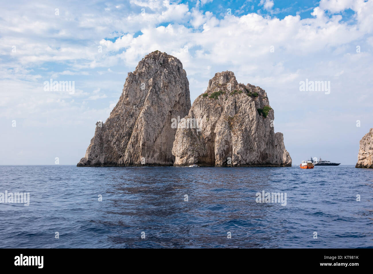 Famous Faraglioni rocks at Capri Island coast seen from the sea, Italy ...