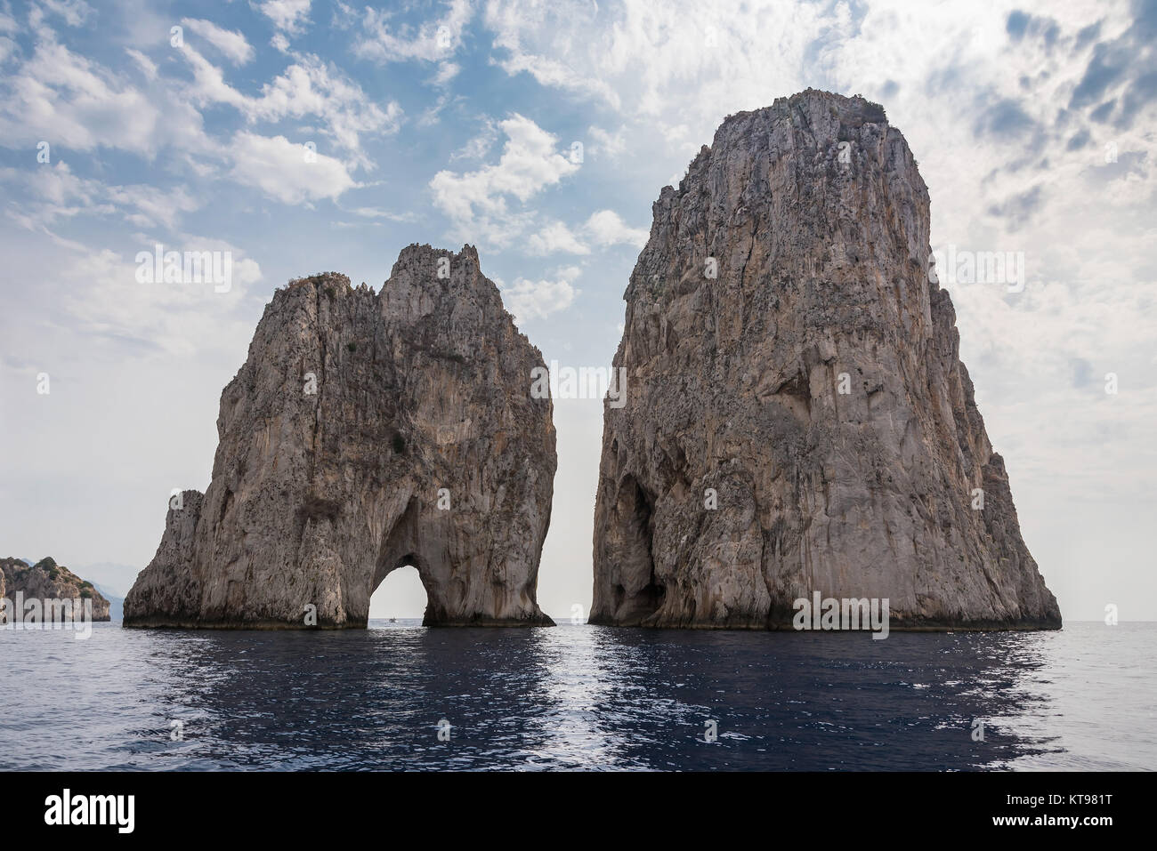 Famous Faraglioni rocks at Capri Island coast seen from the sea, Italy ...