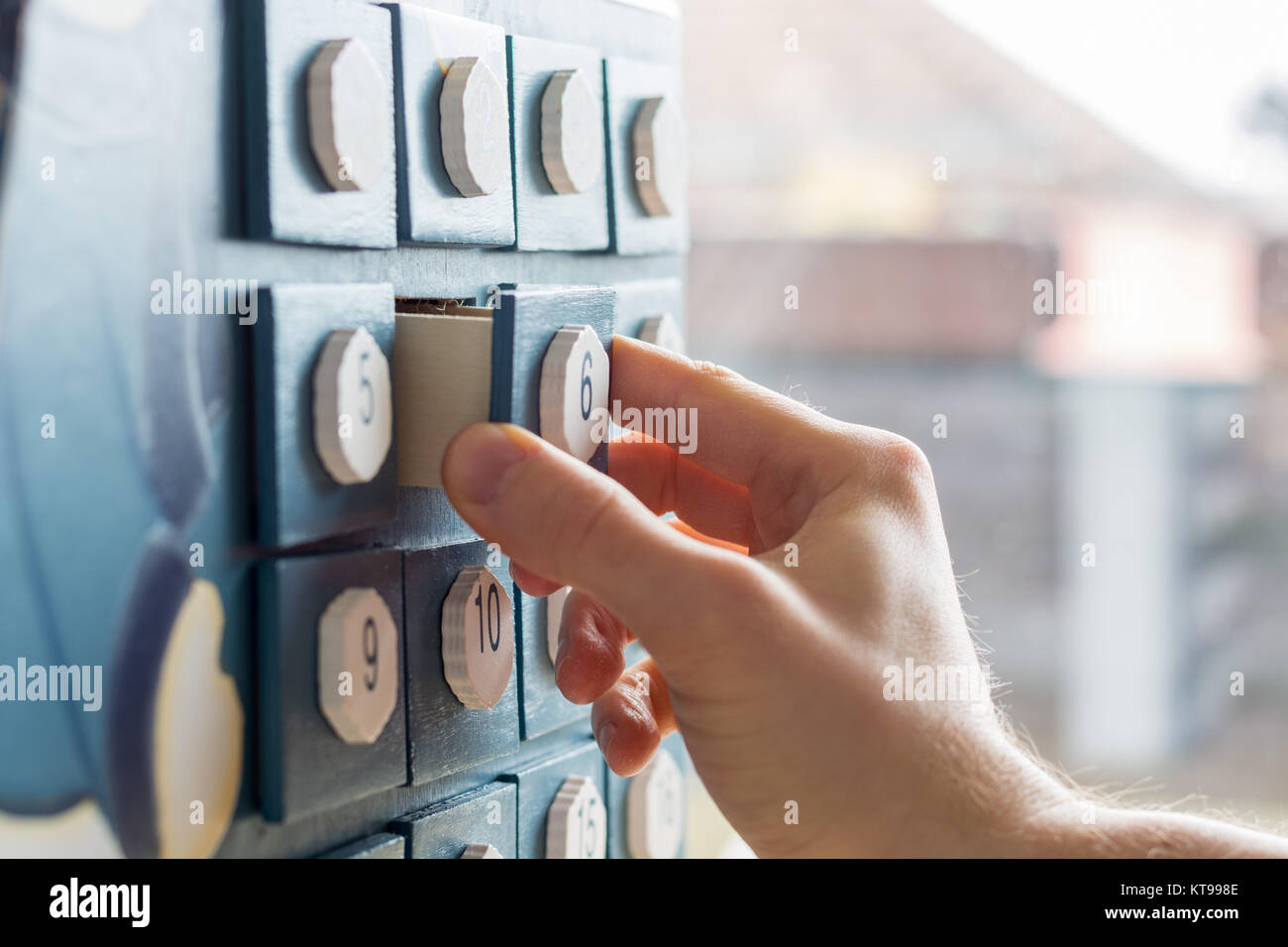 Opening a blue advent calendar close up seen from the side Stock Photo ...