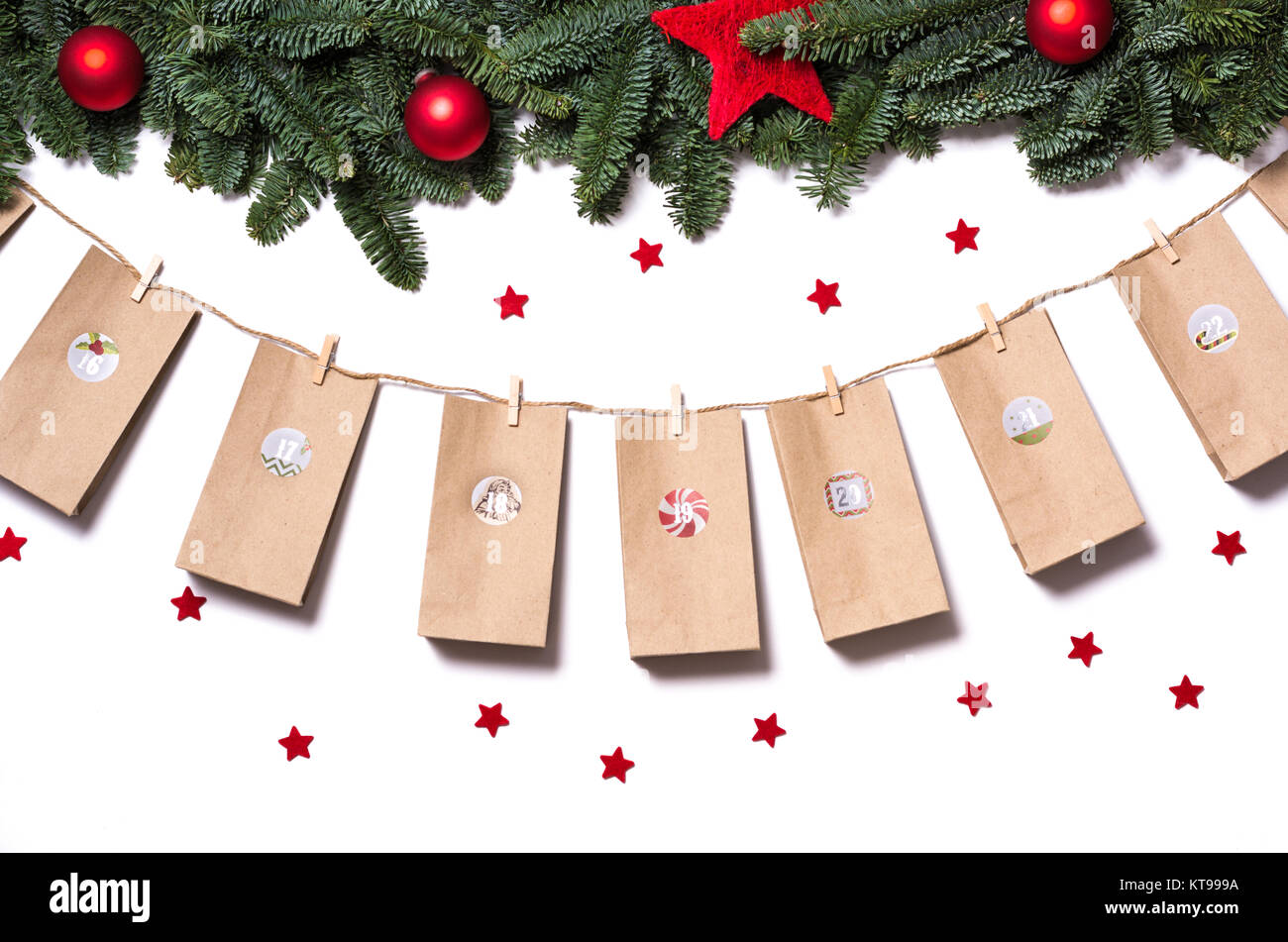 Handmade tinkered advent calendar with paper bags and stickers hanging ...
