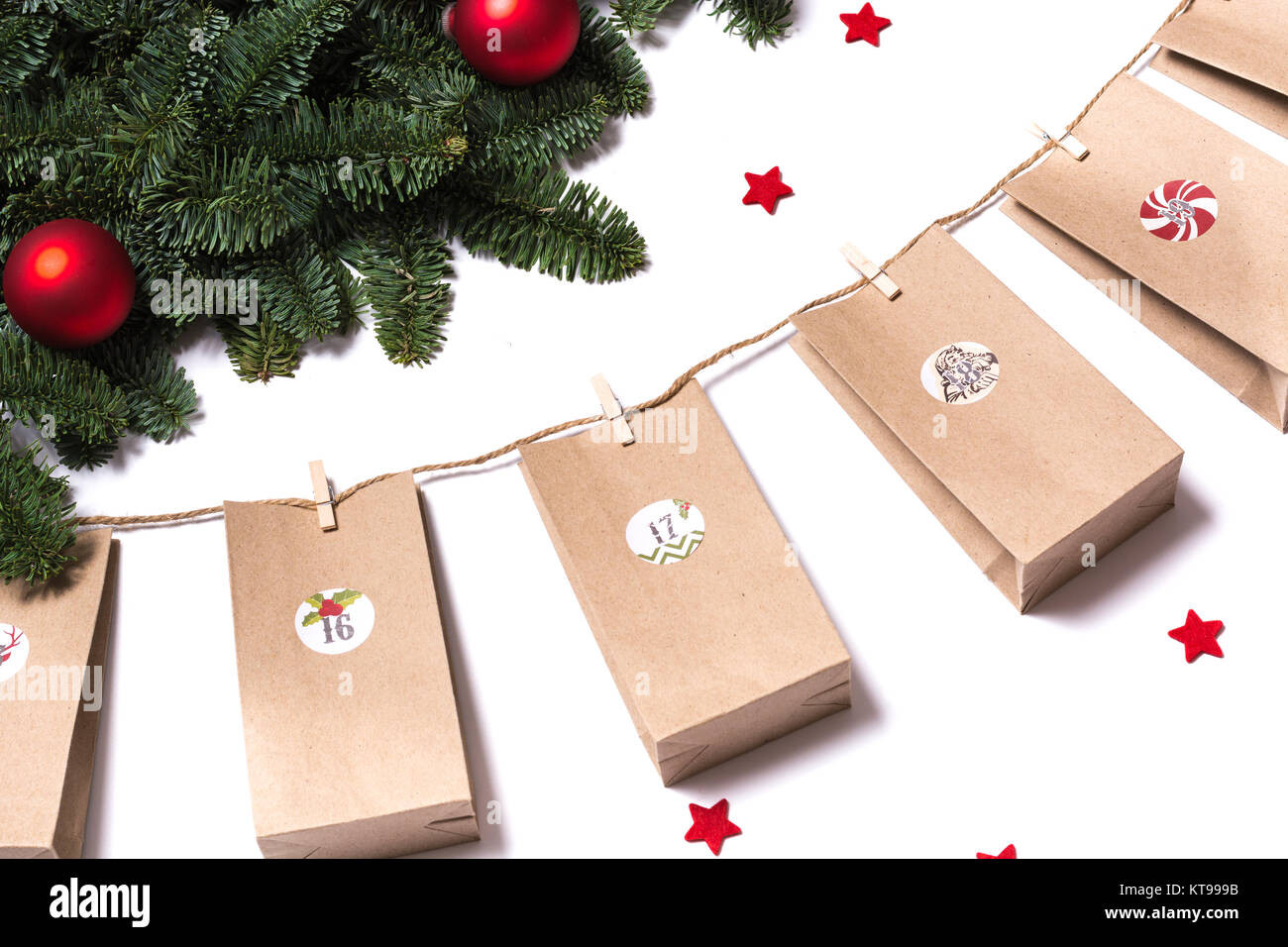Handmade tinkered advent calendar with paper bags and stickers hanging ...