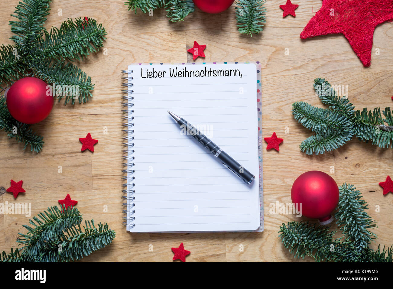 Dear Santa in German on a notepad with Christmas decorations and fir ...