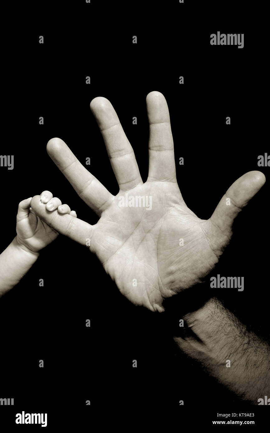 baby trusts in hand holding by adult Stock Photo - Alamy