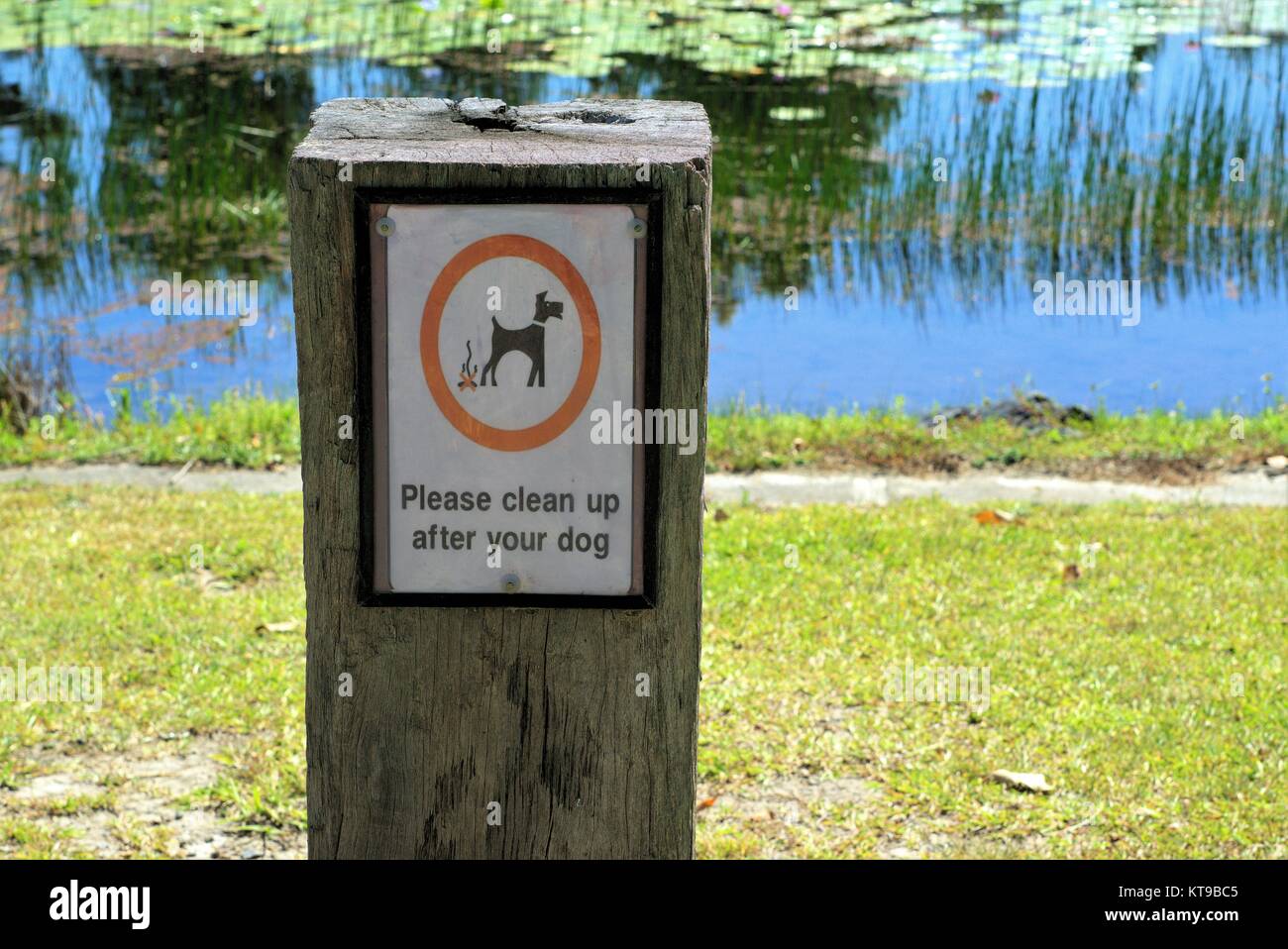 Sign post says 'Please clean up after your dog' at park in Australia ...