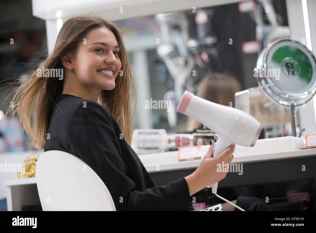 Young woman making her hair Stock Photo - Alamy